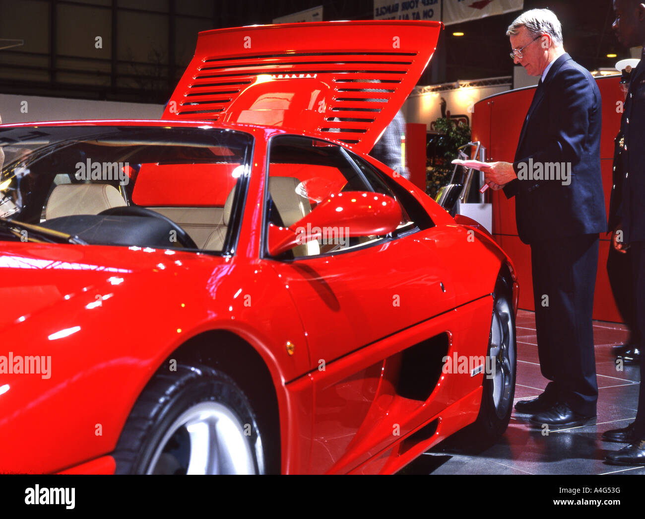 Red Ferrari at car show on purpose designed stand Stock Photo - Alamy