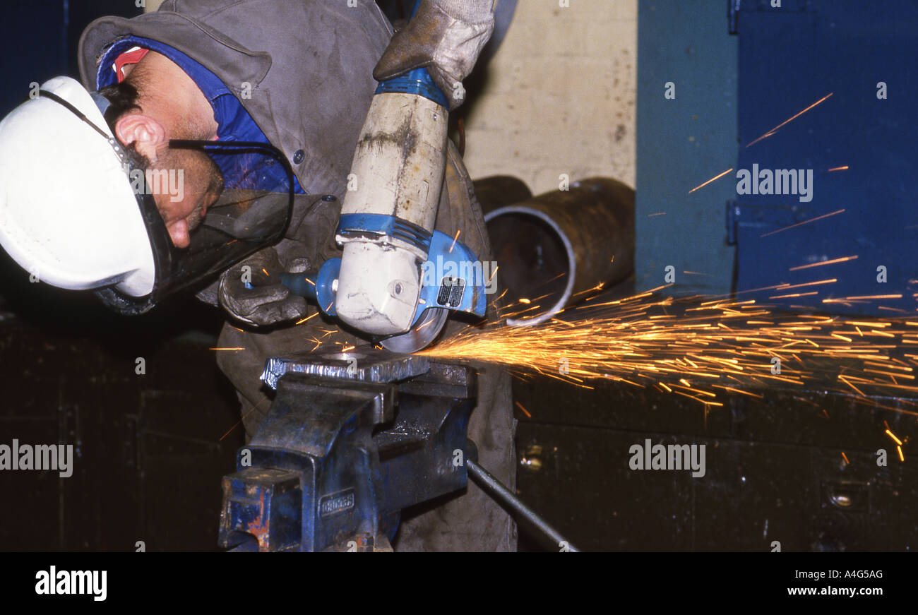 Man using rotary abrasive grinding wheel to work on steel Stock Photo ...