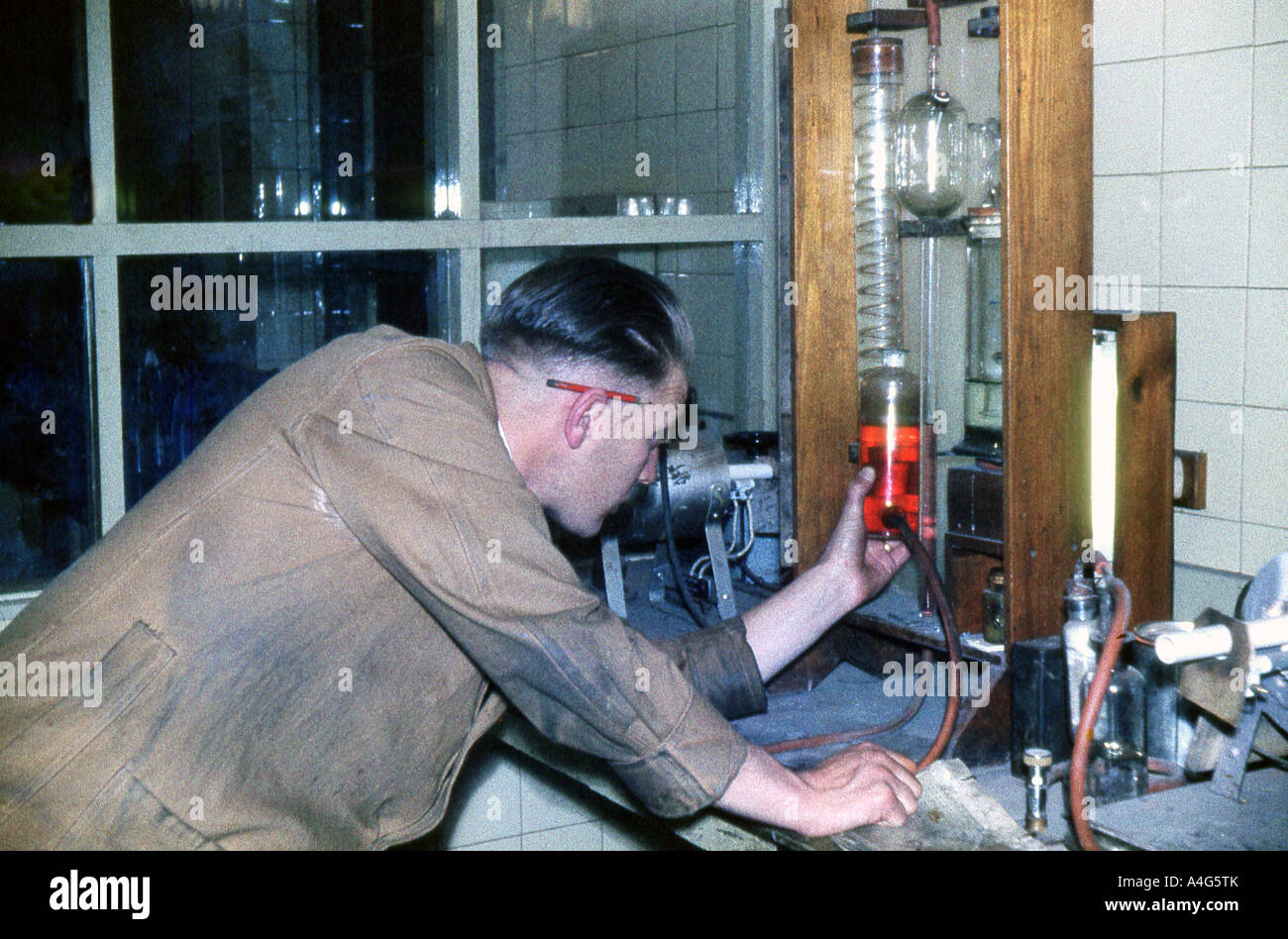 Chemist carrying out carbon analysis on steel sample using Oxygen and ...