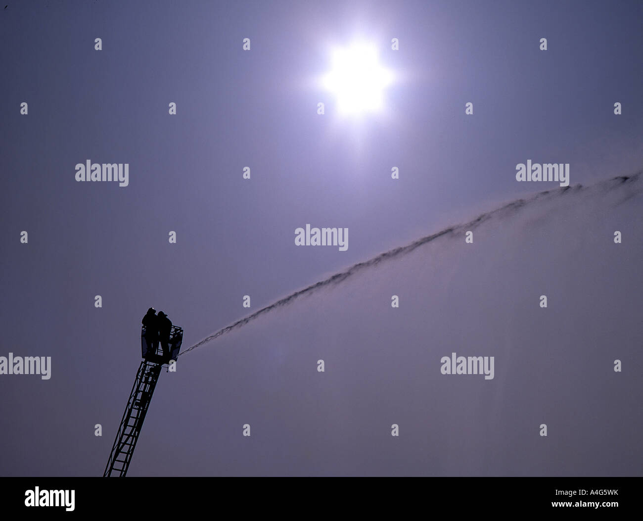 Firemen on high lift ladder testing hose Stock Photo - Alamy