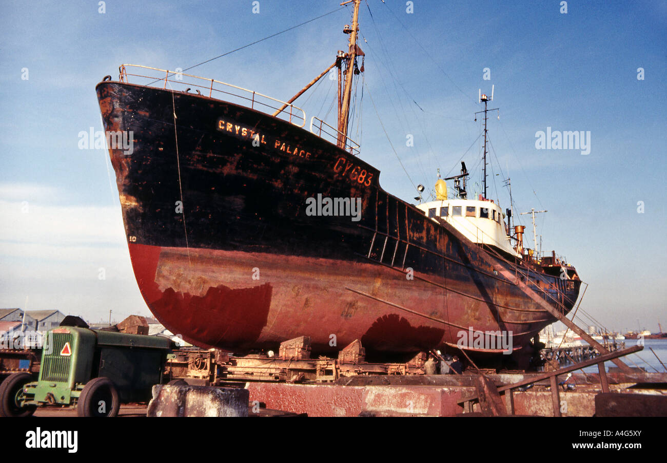 Old trawler out of water on blocks for hull inspection and repair at ...