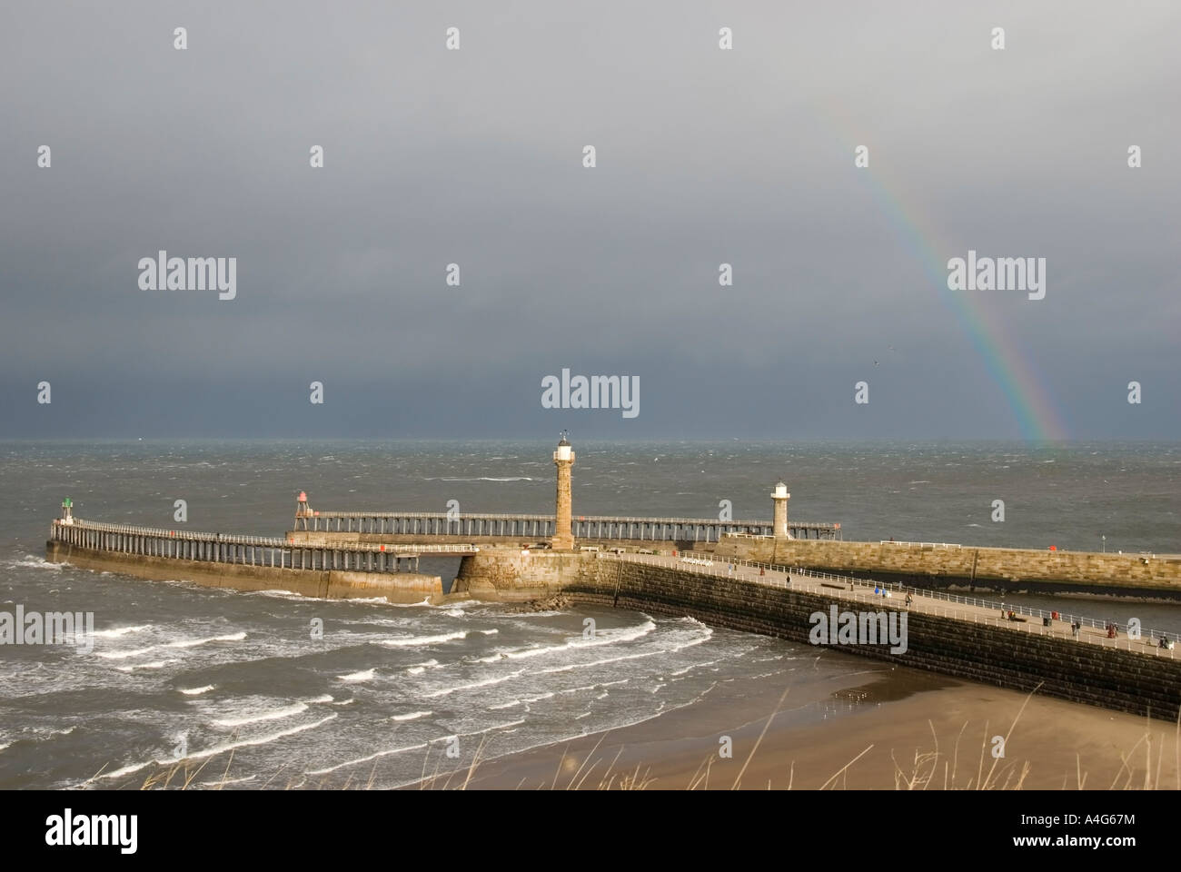 Rainbow over Whitby piers Stock Photo - Alamy