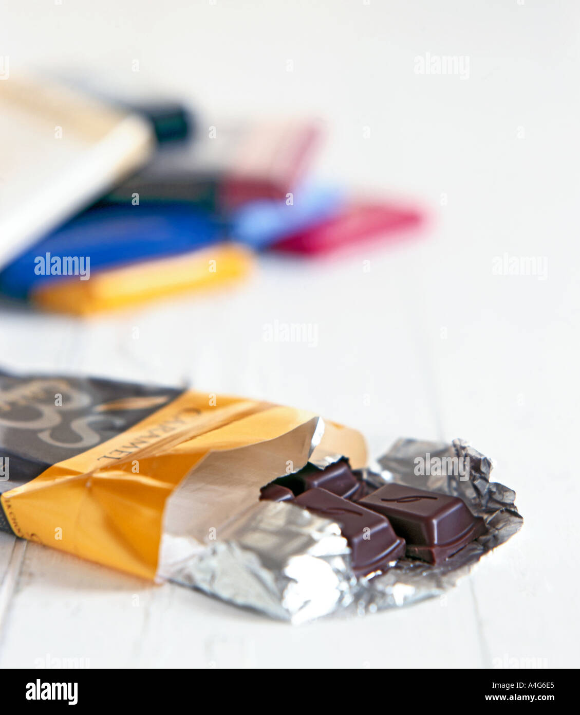 Selection of chocolate bars with one in front open showing dark plain ...