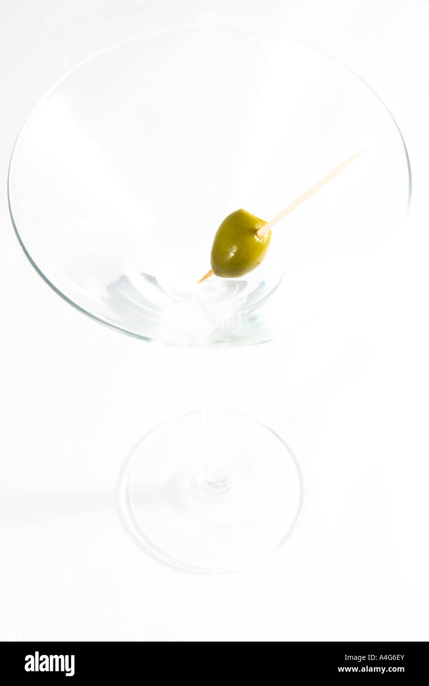 Olive sitting in Martini glass on white background short DOF Stock ...