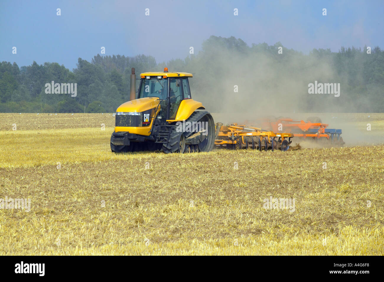 Caterpillar tractor and disc harrow Stock Photo - Alamy