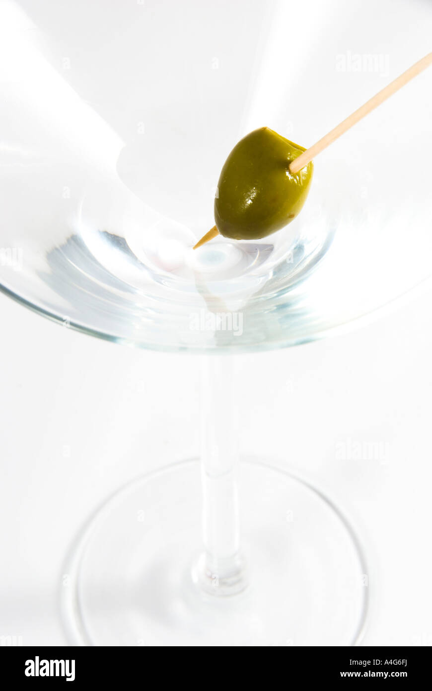 Olive sitting in Martini glass on white background short DOF Stock ...