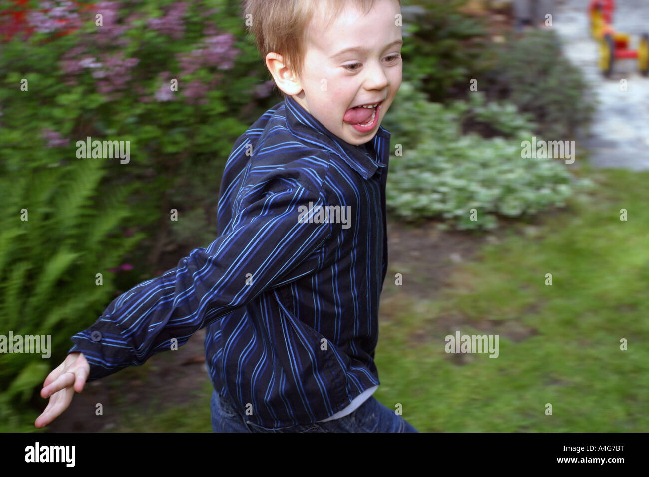 young child running around garden Stock Photo - Alamy