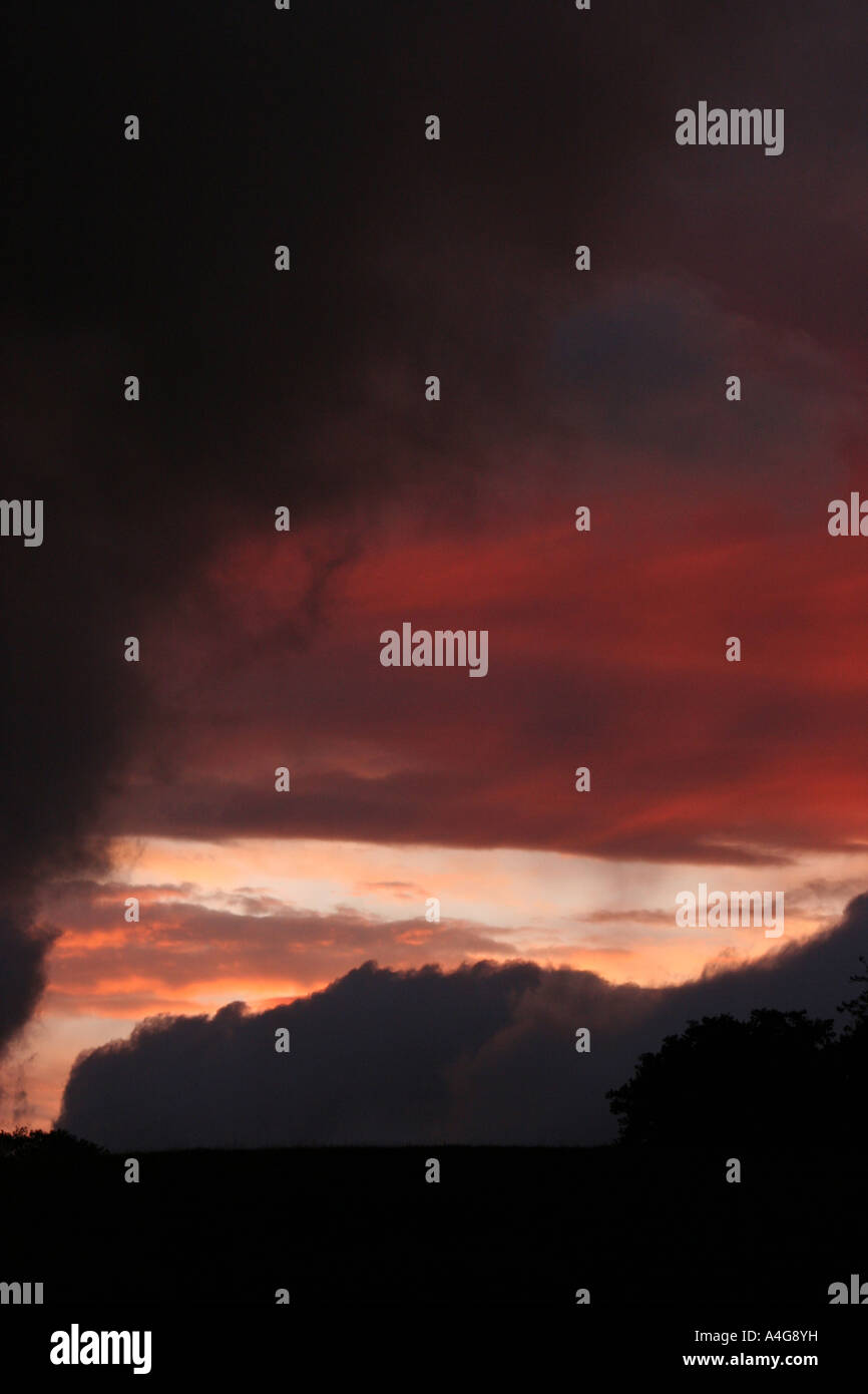 Dramatic opening in evening sky, tornado like dark cloud Stock Photo ...