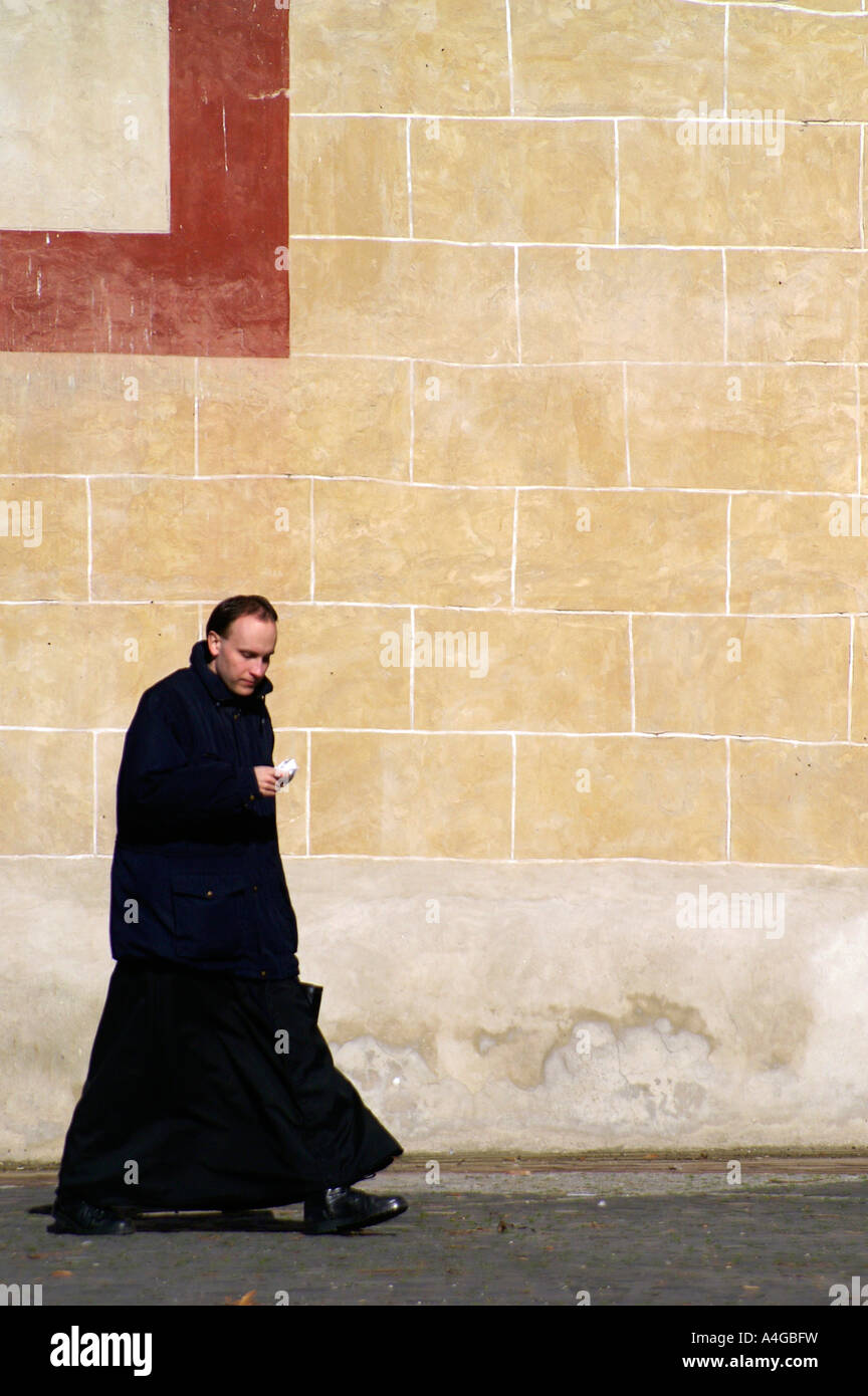 Priest walking under Red line edge of rectangle on stone wall of gothic ...