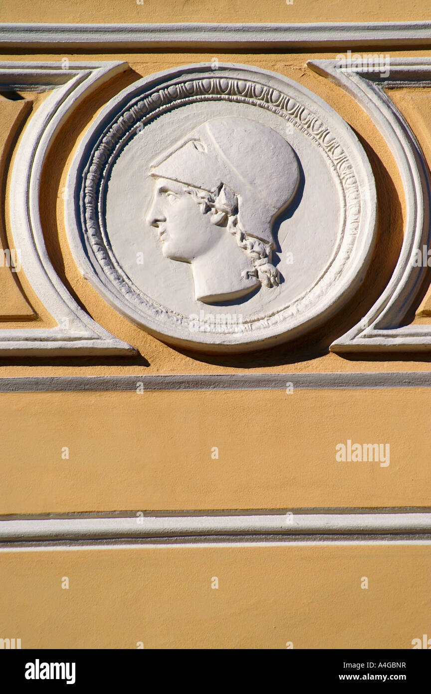 White roman centurion head relief on yellow facade of baroque house in ...
