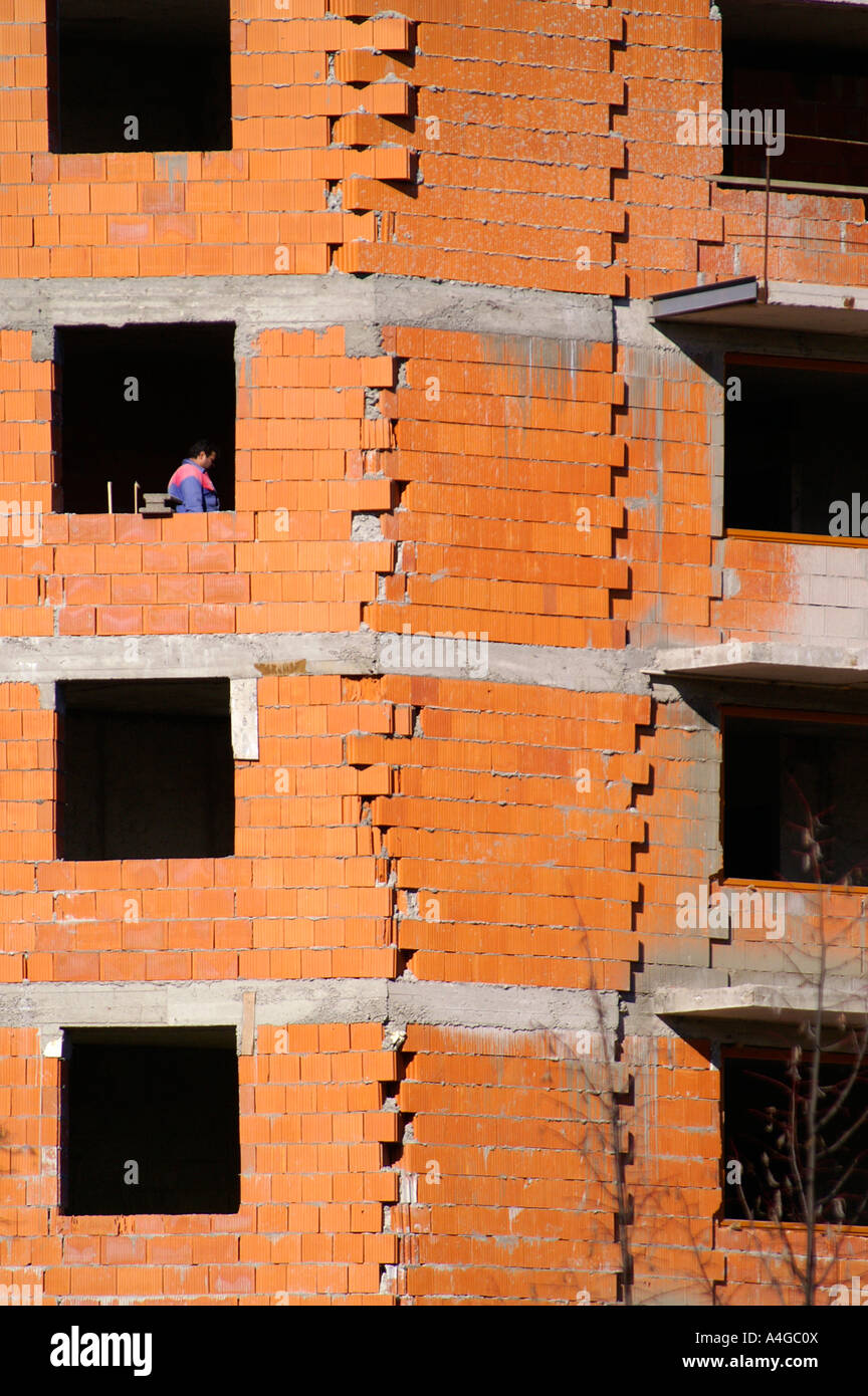 Construction site of brick wall building with openings for windows and ...