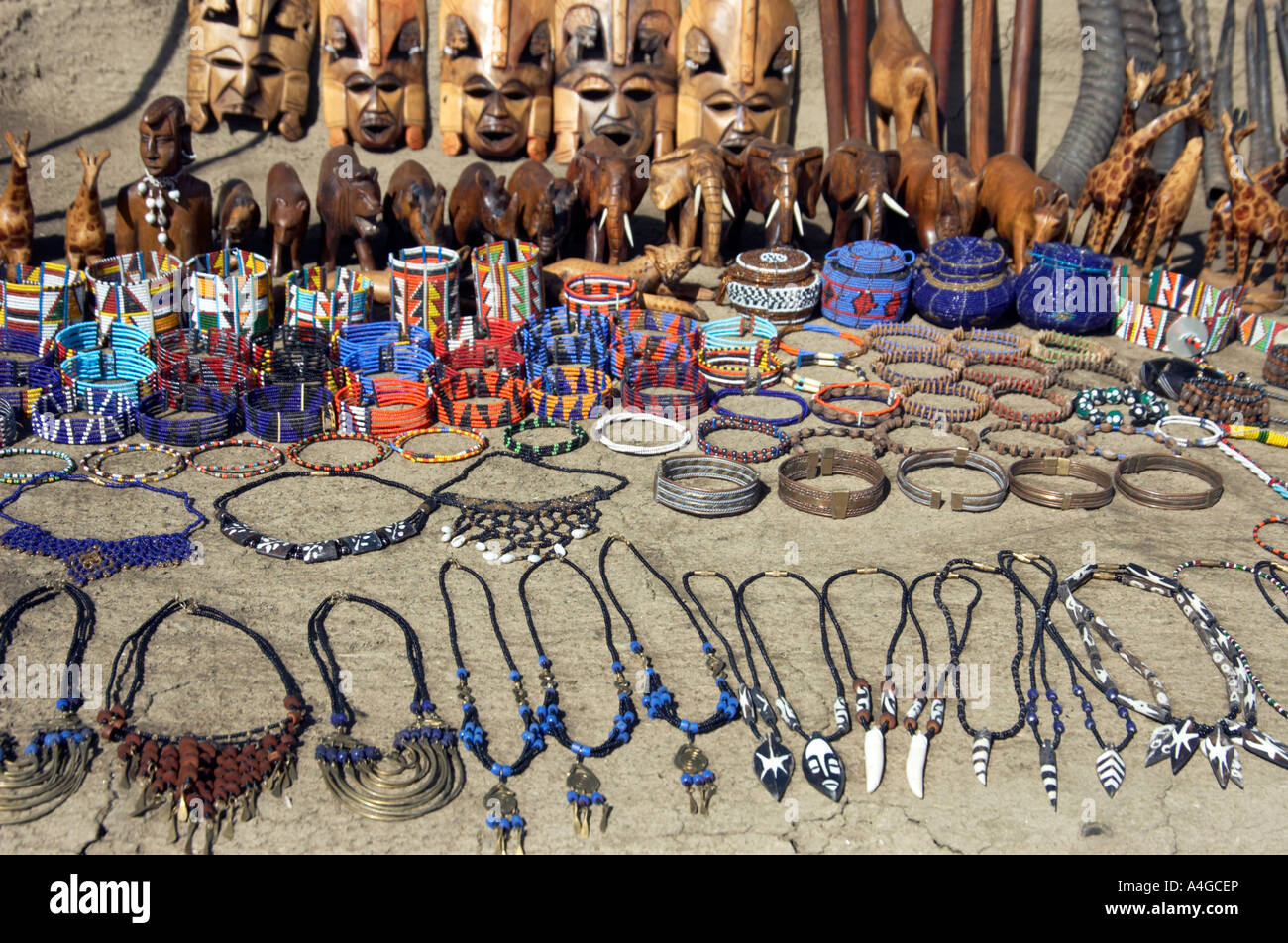 A display of jewelry and wooden carvings at a market in Kenya Stock ...