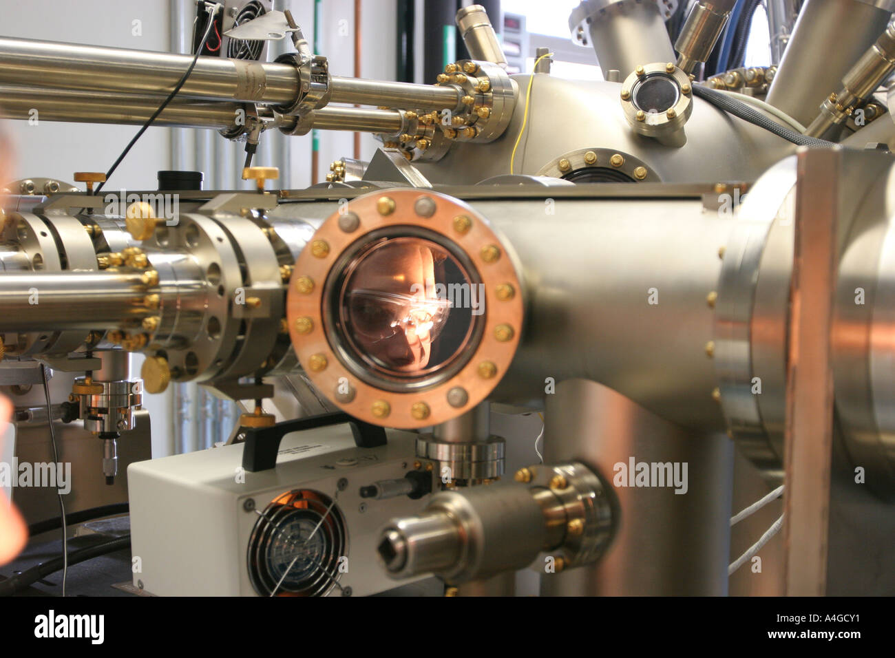 Face reflected in veiw port on molecular beam epitaxy system at ...