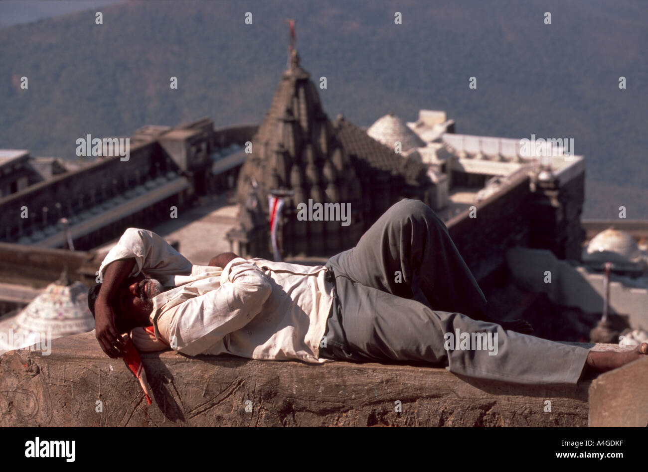 Man resting in front of Neminath Jain temple on Mt. Grinar, Junagadh ...