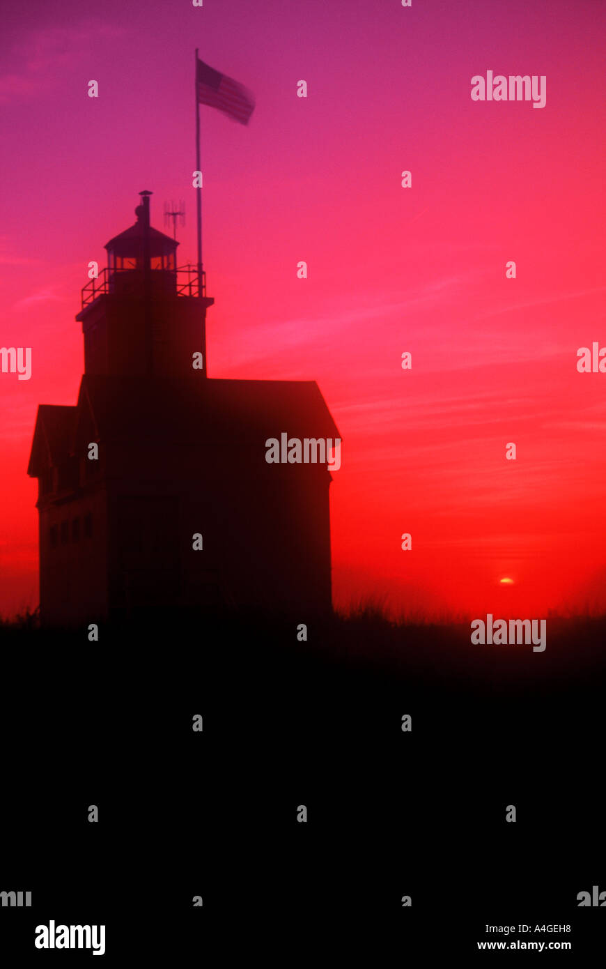 Holland Michigan lighthouse during a red and purple sunset Stock Photo ...