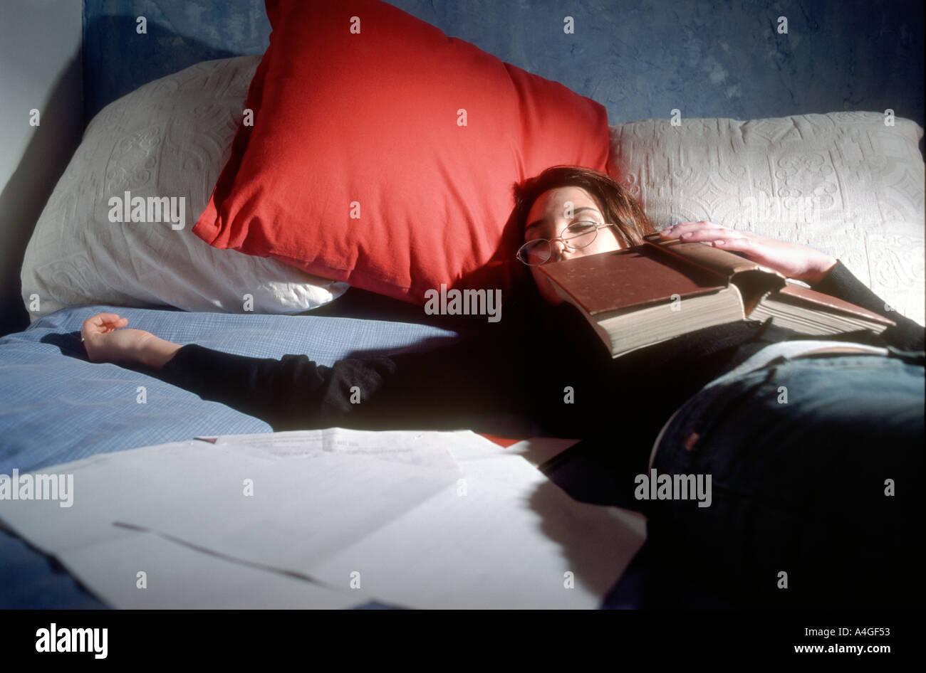 student falls asleep while reading in bed Stock Photo - Alamy