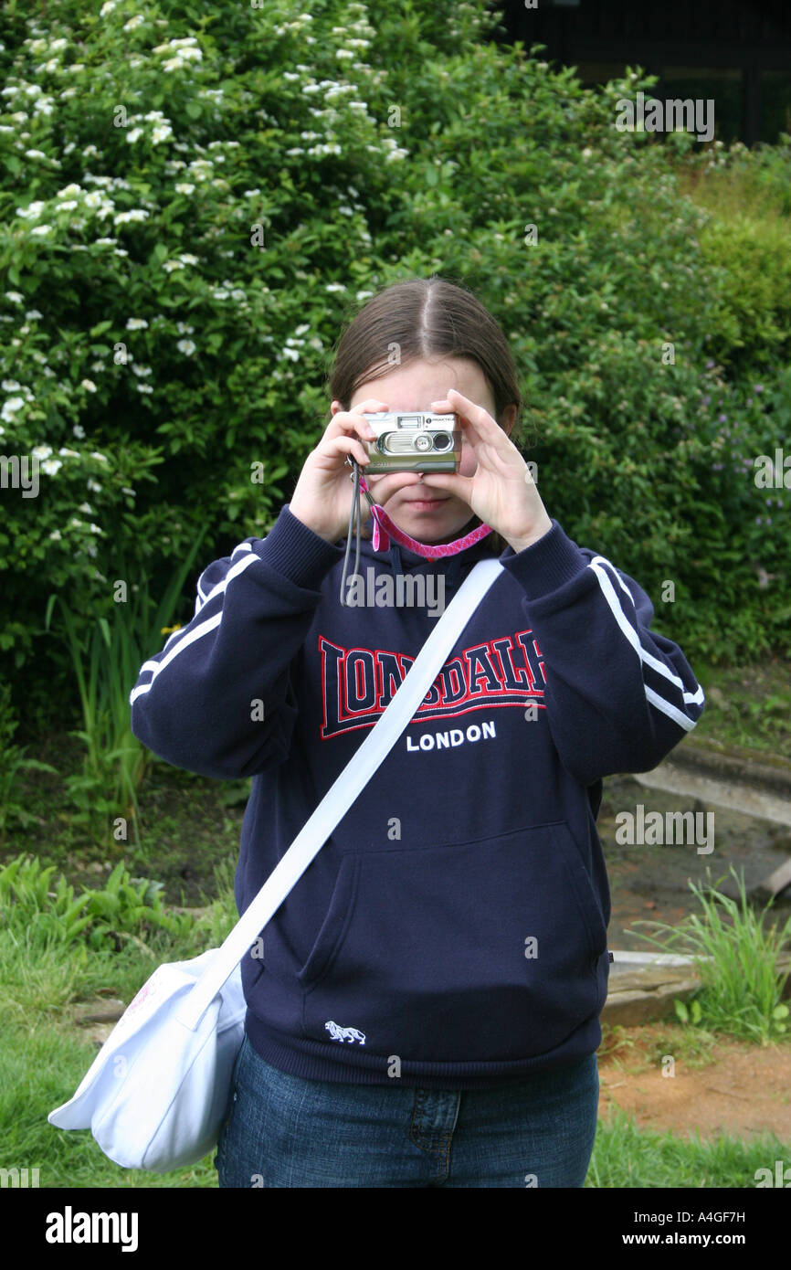 Young teenage girl photographer taking photograph with compact digital ...