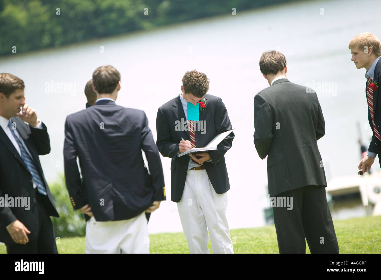 Graduating senior year pupils gather on lawn by lake after Commencement ...