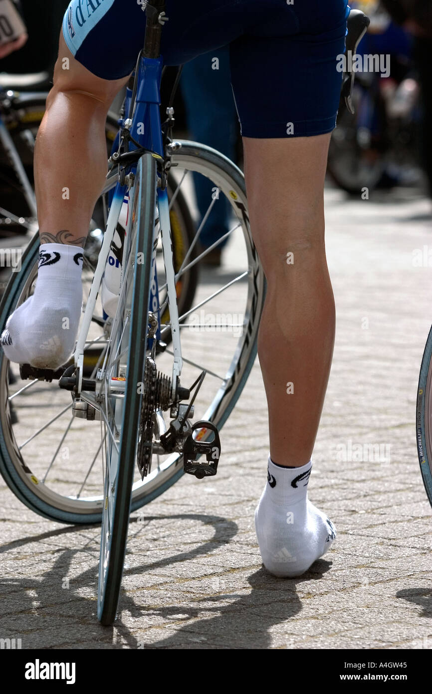 wheel of racing bicycle on track and legs Stock Photo - Alamy