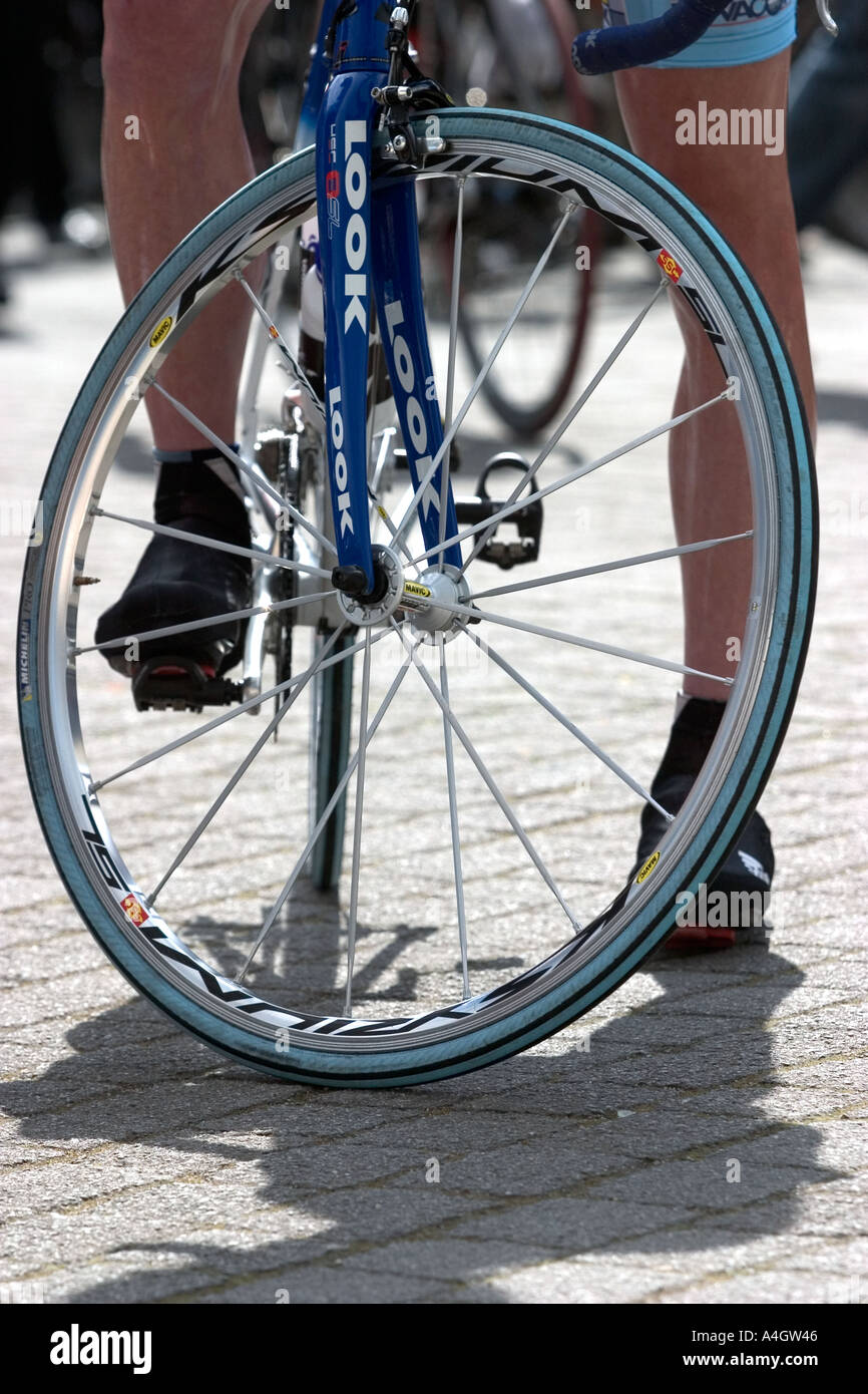 wheel of racing bicycle on track and legs Stock Photo - Alamy