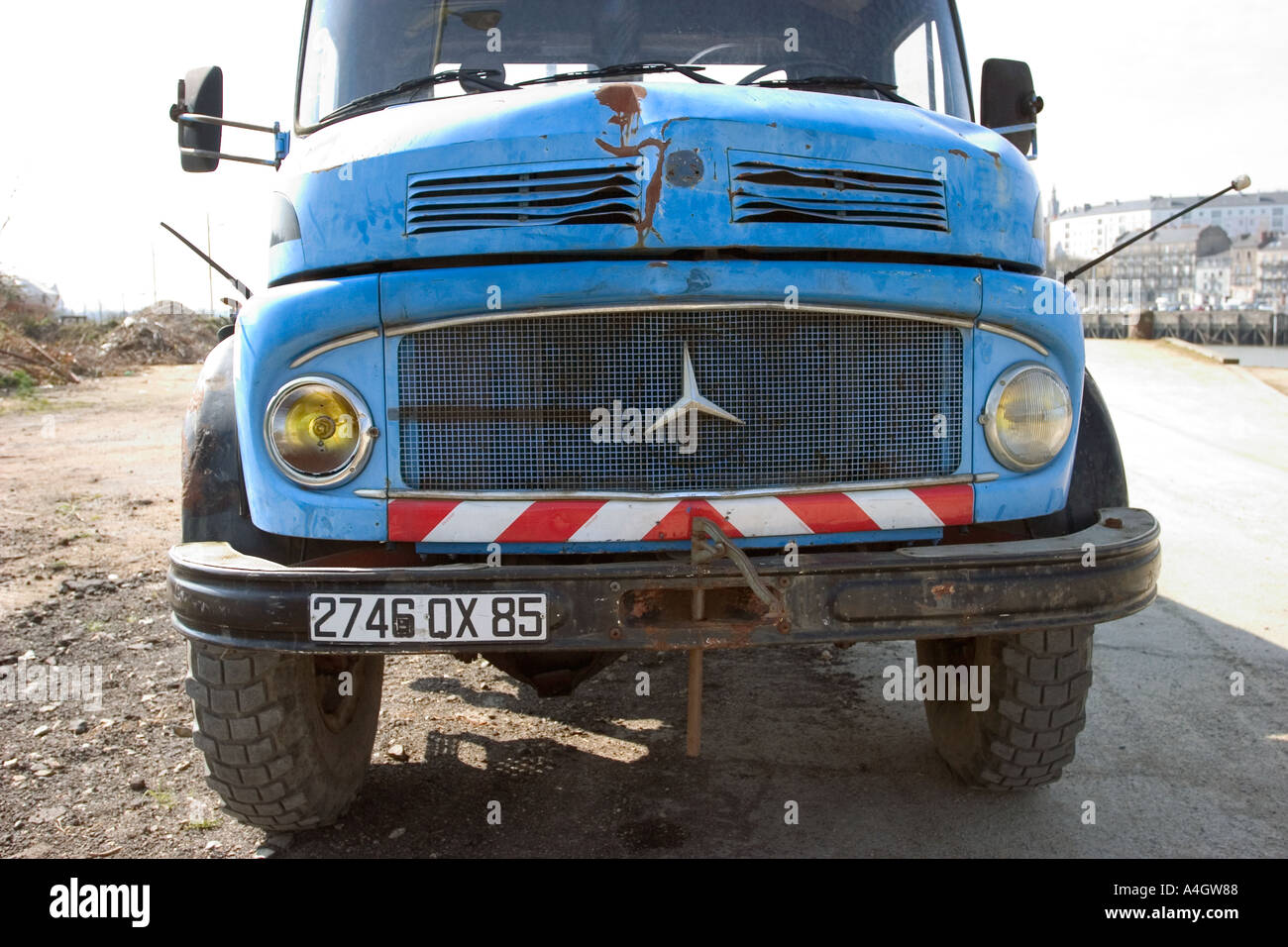 old blue mercedes truck with crane in back abandoned Stock Photo - Alamy