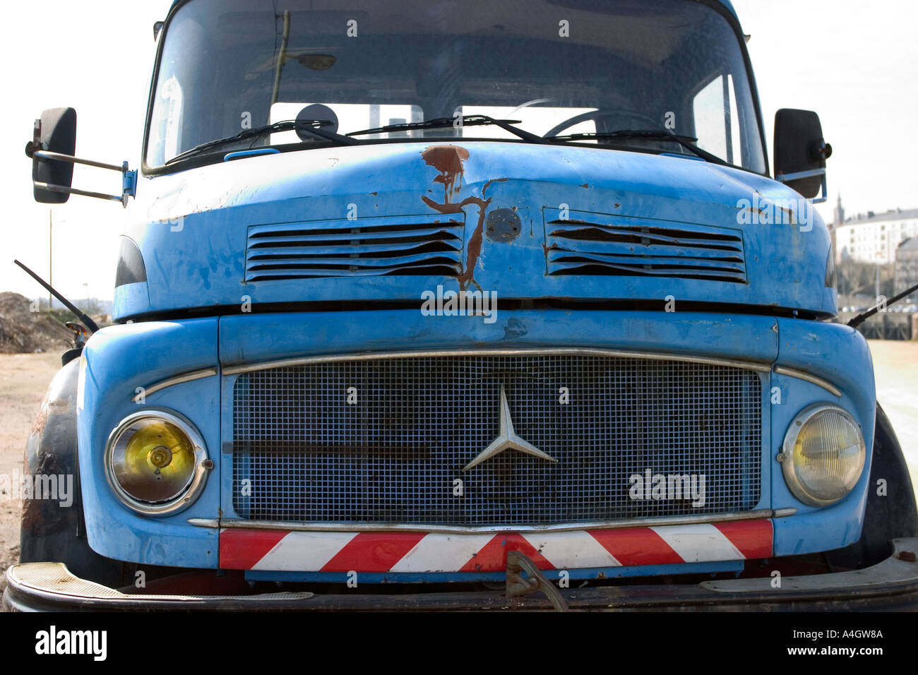 old blue mercedes truck with crane in back abandoned Stock Photo - Alamy