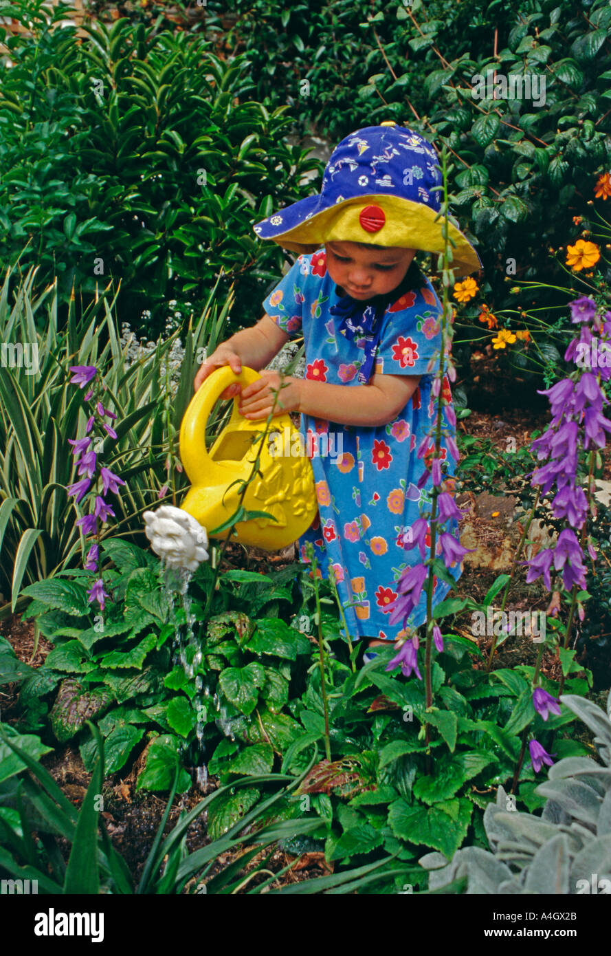 Child using watering can hi-res stock photography and images - Alamy