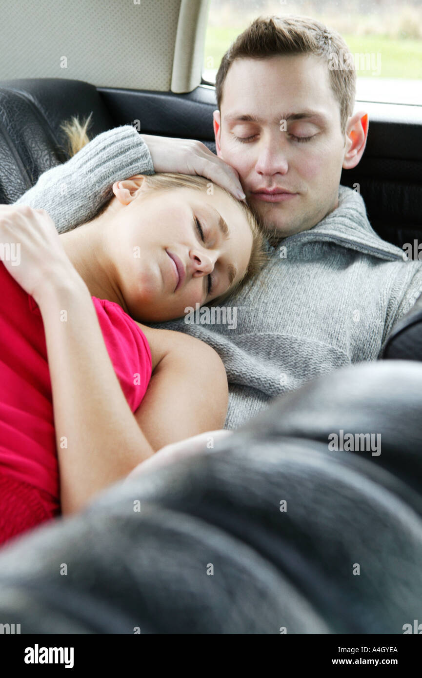 Couple hugging in back of car Stock Photo - Alamy