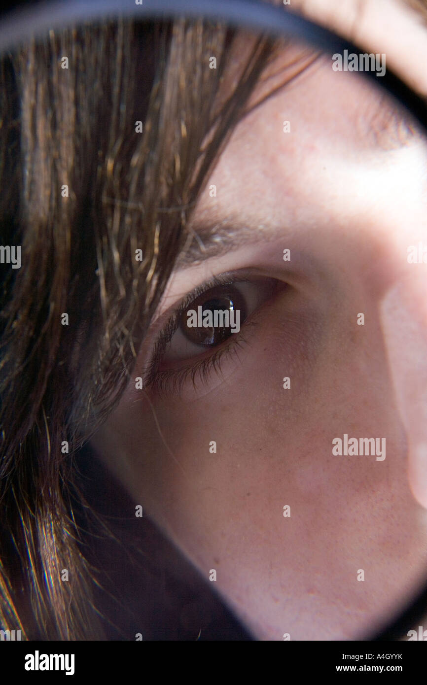 Young man or teenager eye only looking through magnifying glass Stock ...