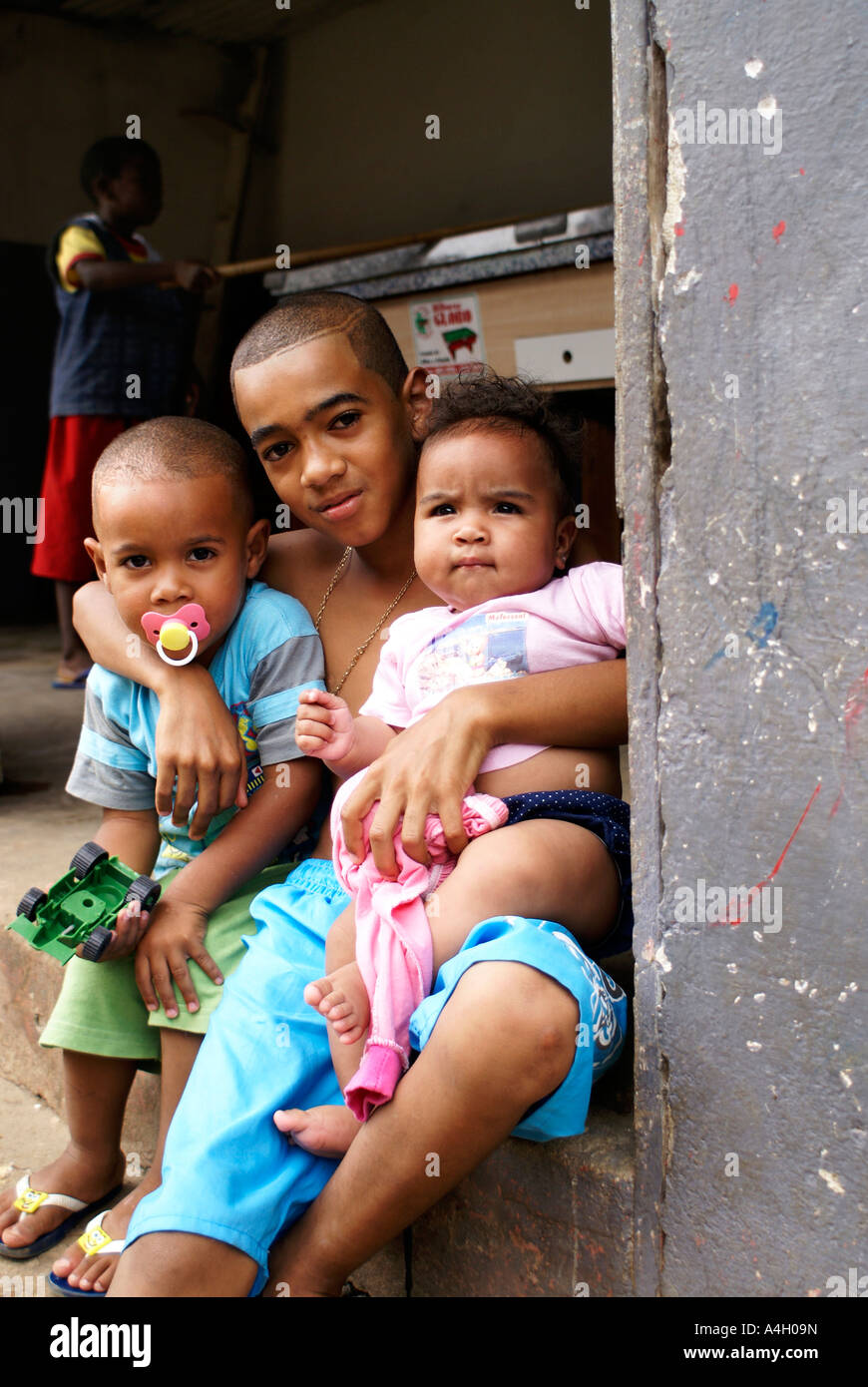 Boy with two younger brothers on the street in a favela, Sao Paulo ...