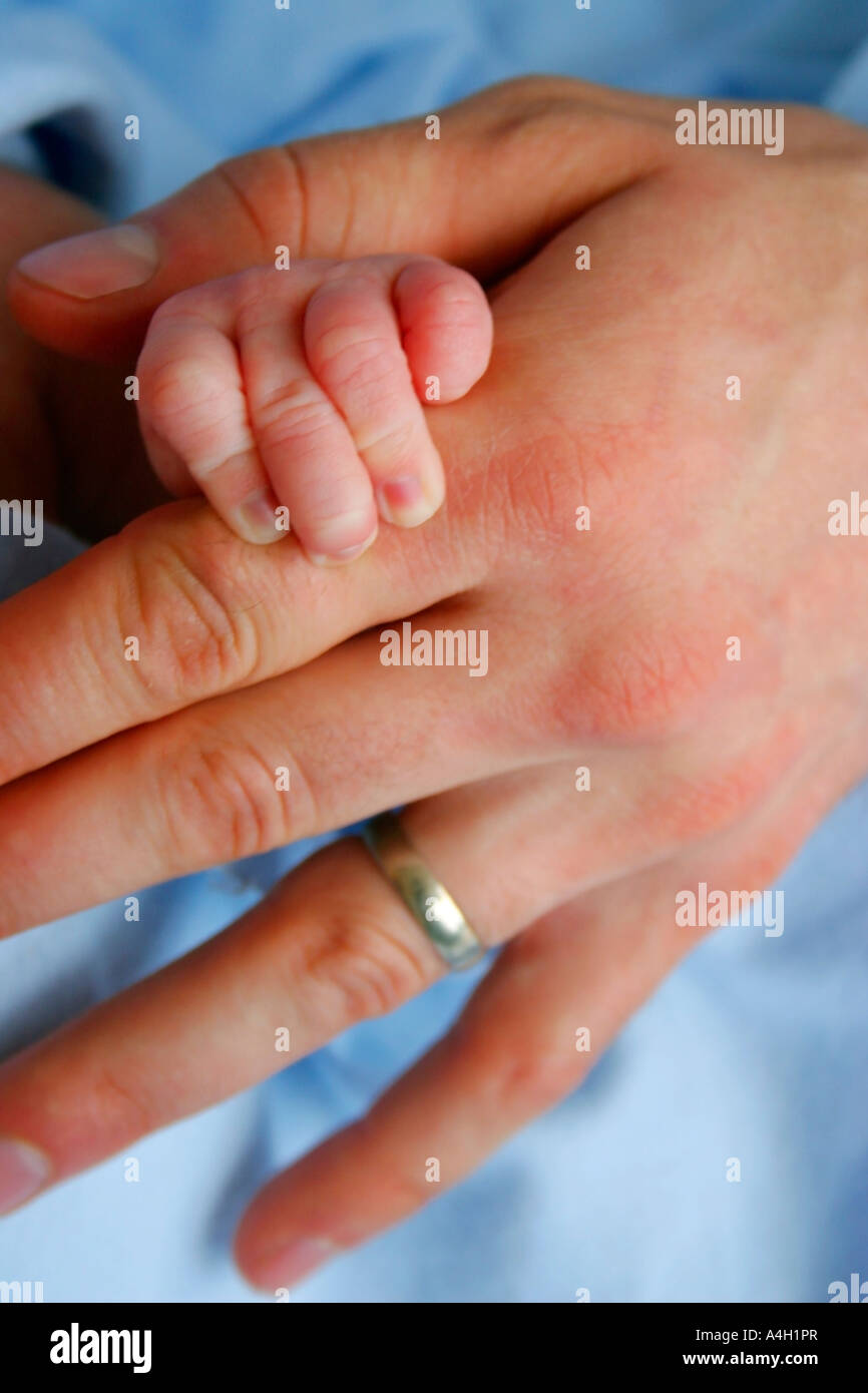 Baby clinging to dad Stock Photo - Alamy