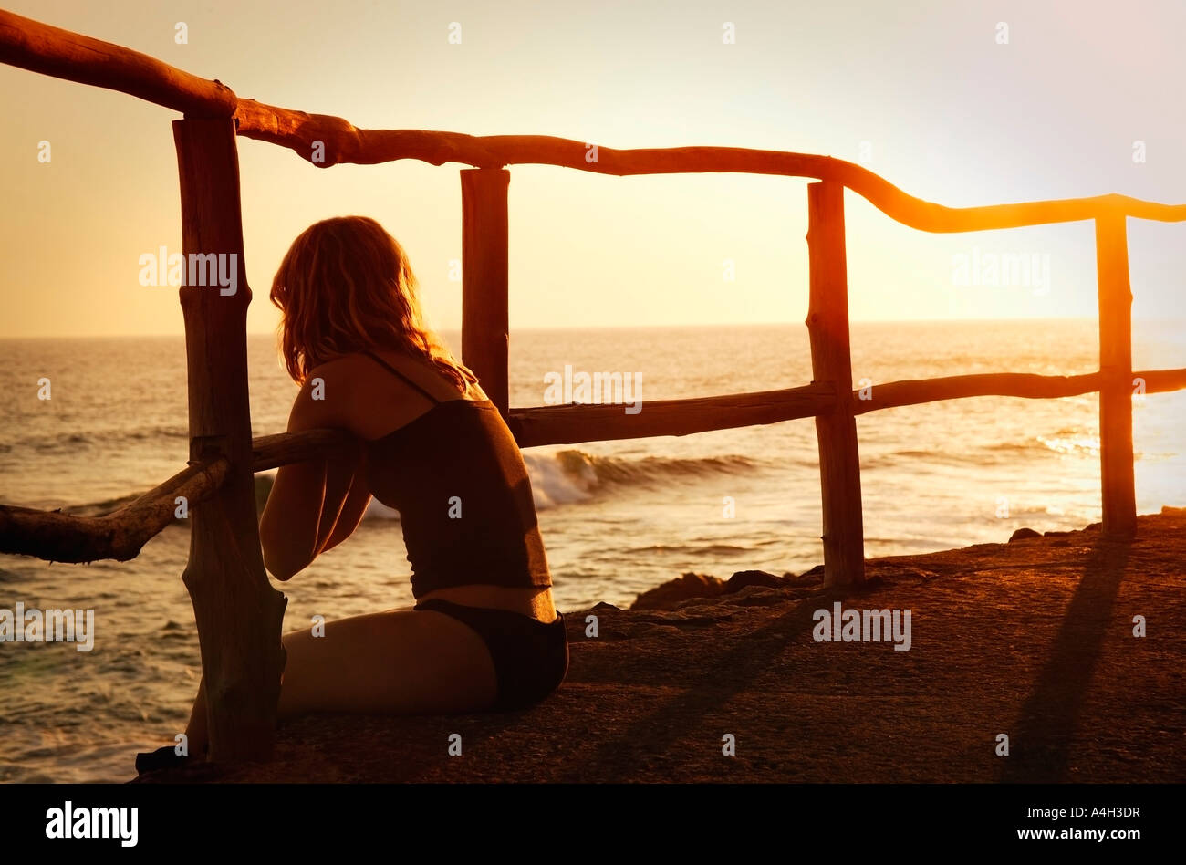 Sitting on the edge Stock Photo - Alamy