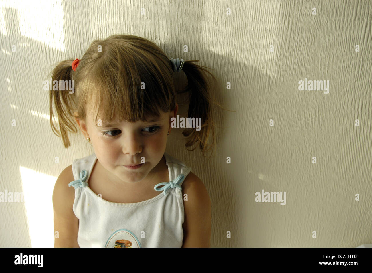 Girl looking down pony tail hi-res stock photography and images - Alamy