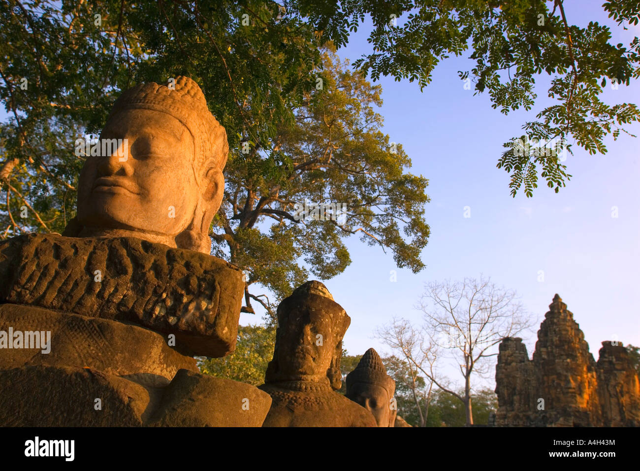 Head statues and distant ruins Angkor Wat Temple Complex Angkor Thom ...
