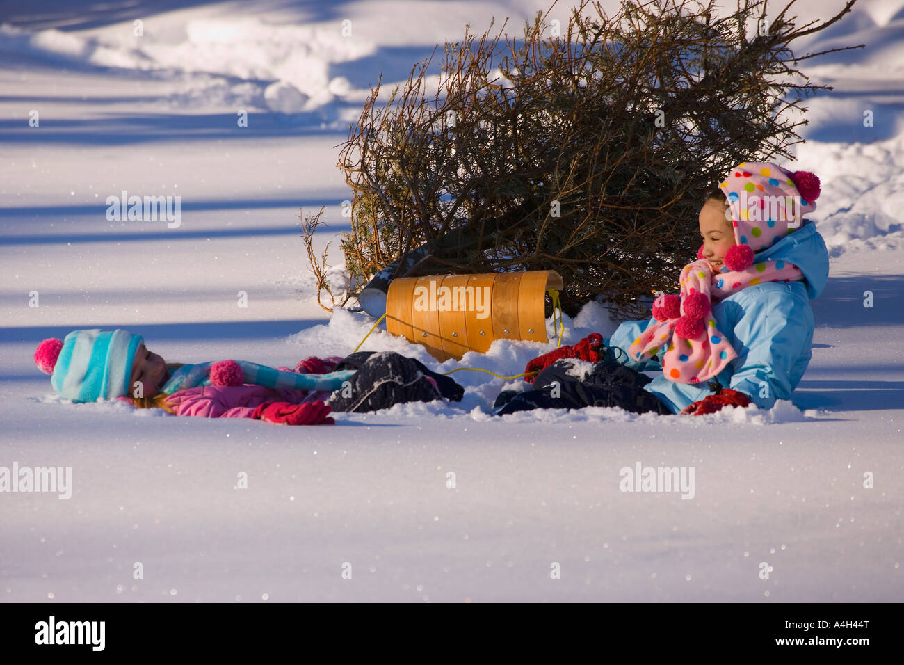 Girls resting in the snow Stock Photo - Alamy