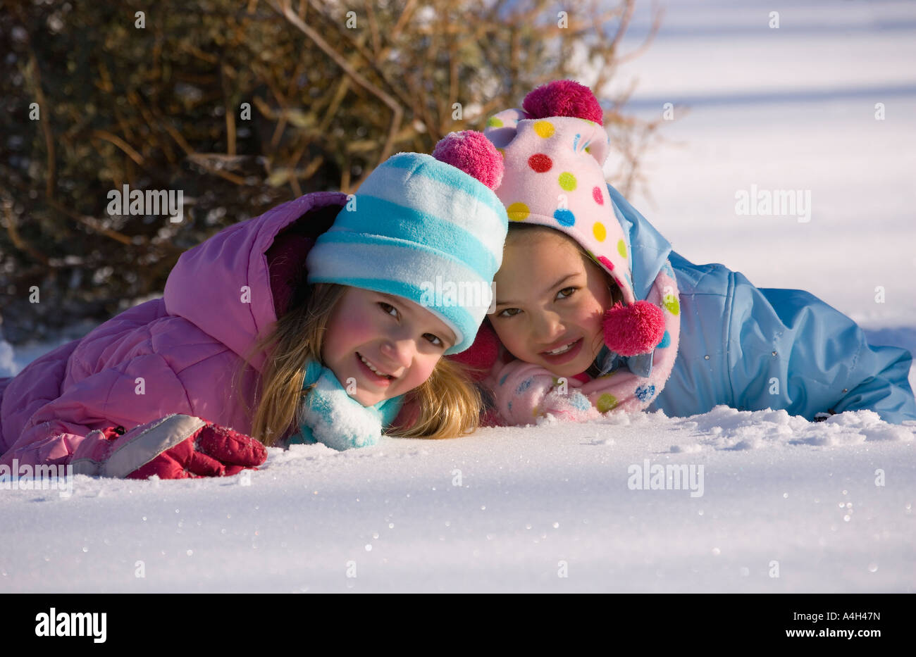 Girls resting in the snow Stock Photo - Alamy