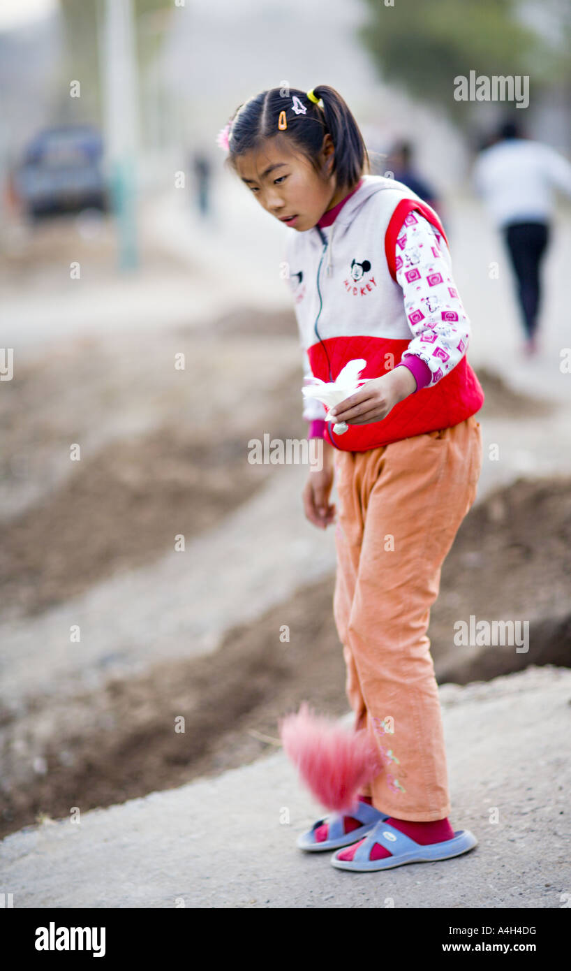 CHINA SIMATAI Young Chinese girl playing with hacky sacks or Jianxi ...