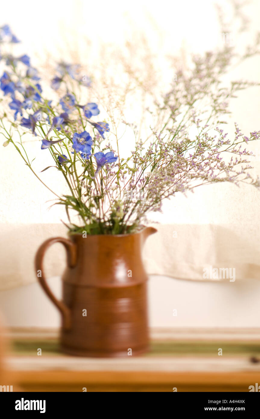 Flowers in a water pitcher Stock Photo - Alamy