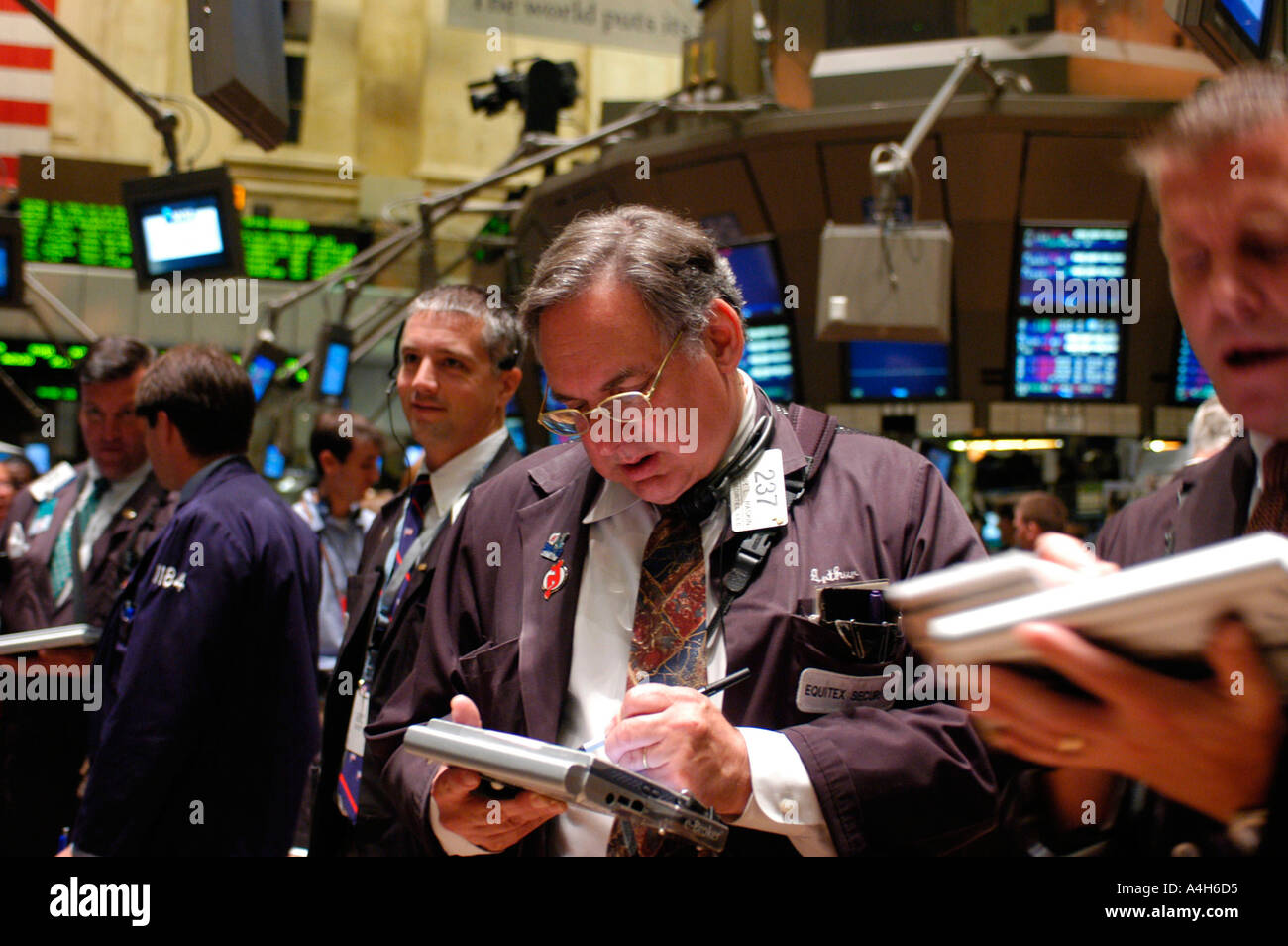 Stockbrokers busy on the trading floor of the New York Stock Exchange ...