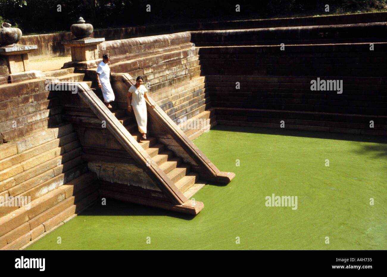 Two women take a closer look at the water in one of the many ancient ...