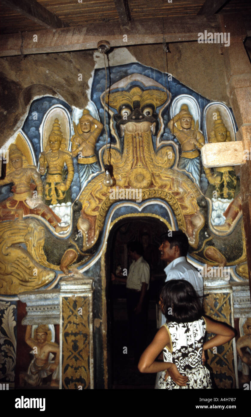 Sri Lankan visitors see one of the two cave temples at the site of the ...