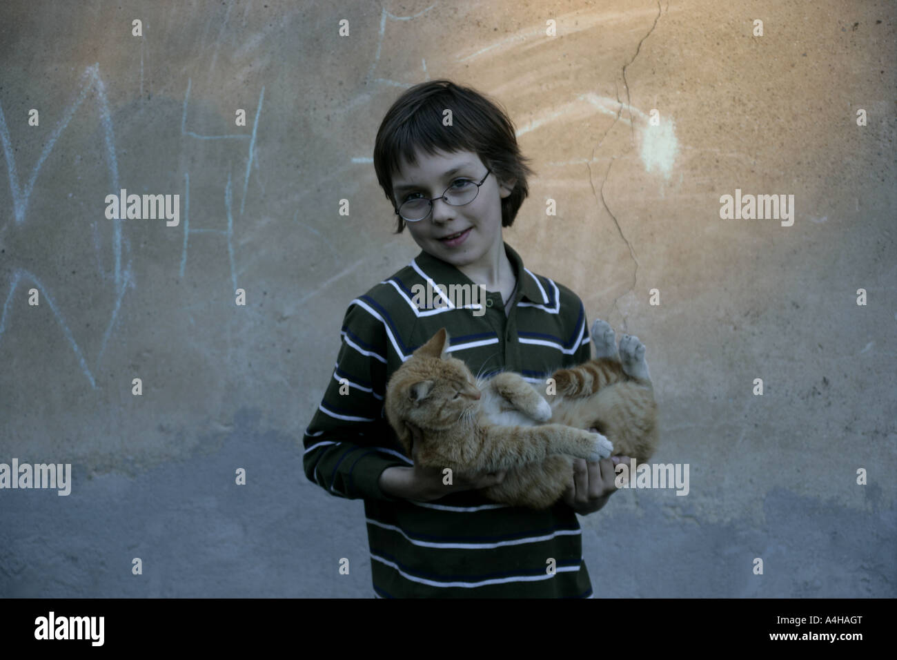 A boy holding a cat Stock Photo - Alamy