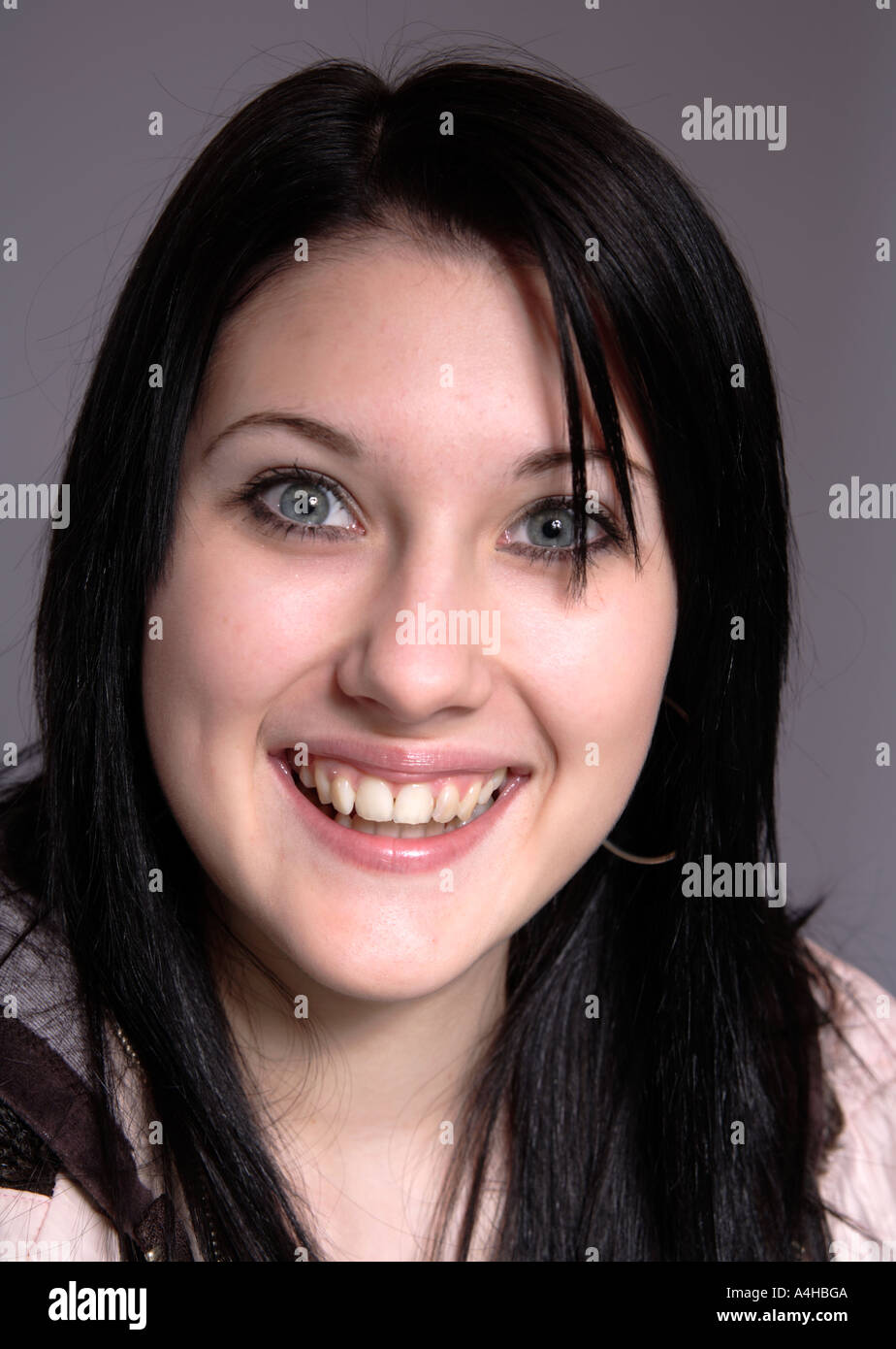 Young girl aged 16 with black hair with happy surprised look eyes wide ...