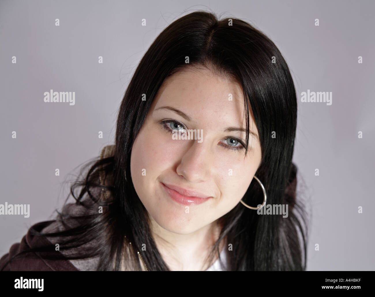 Young girl aged 16 with black hair upwards confident look Stock Photo ...