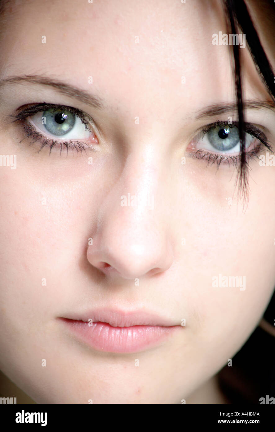 Close up of Young girl aged 16 with black hair upwards confident look ...