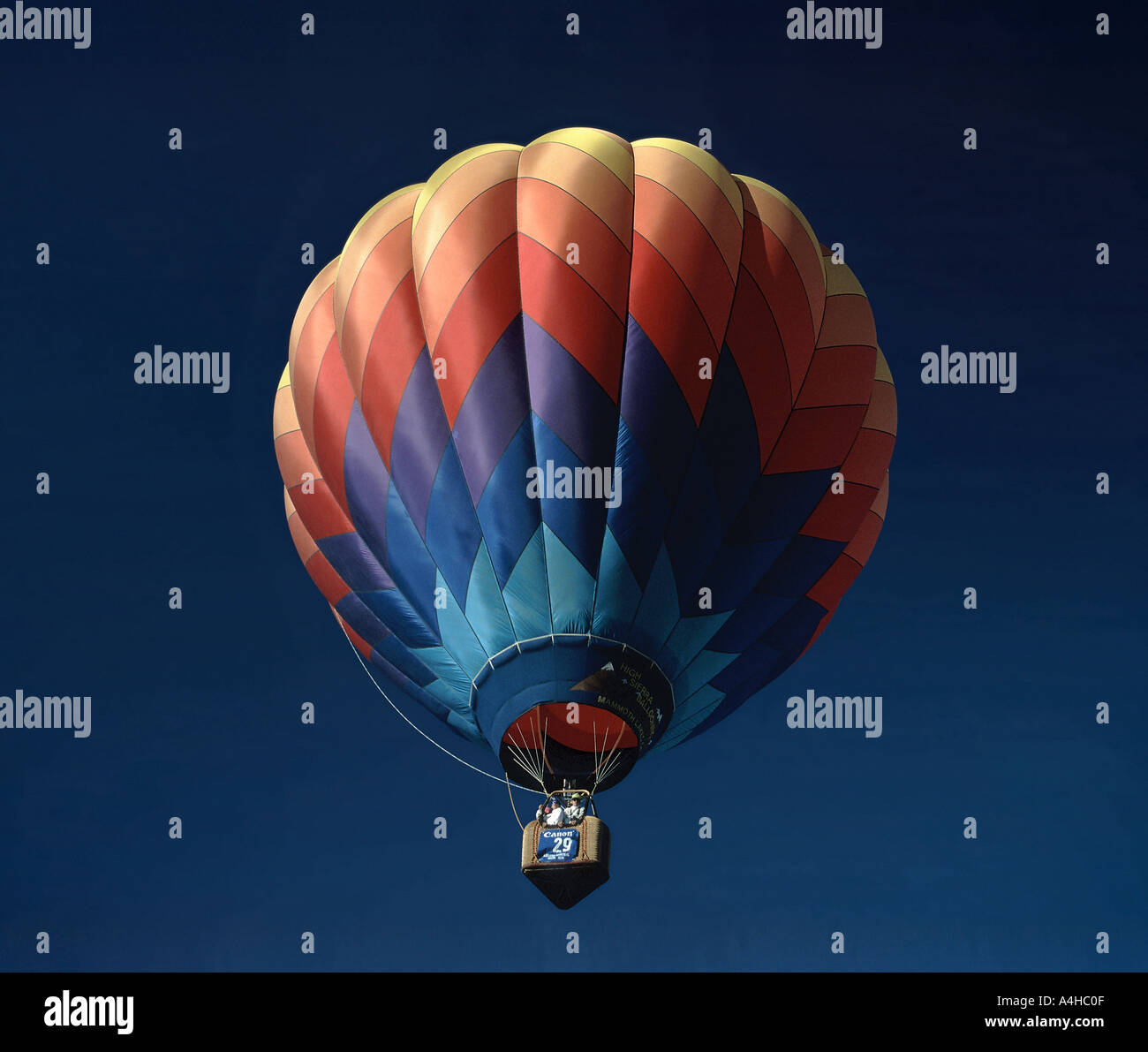 Large colorful hot air balloon quietly drifting in the air Stock Photo ...