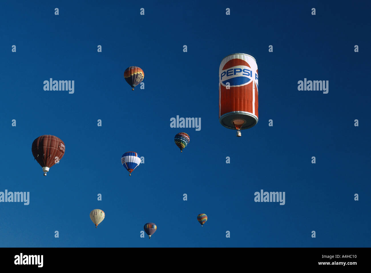Hot air balloons one of which looks like a familiar soft drink can ...