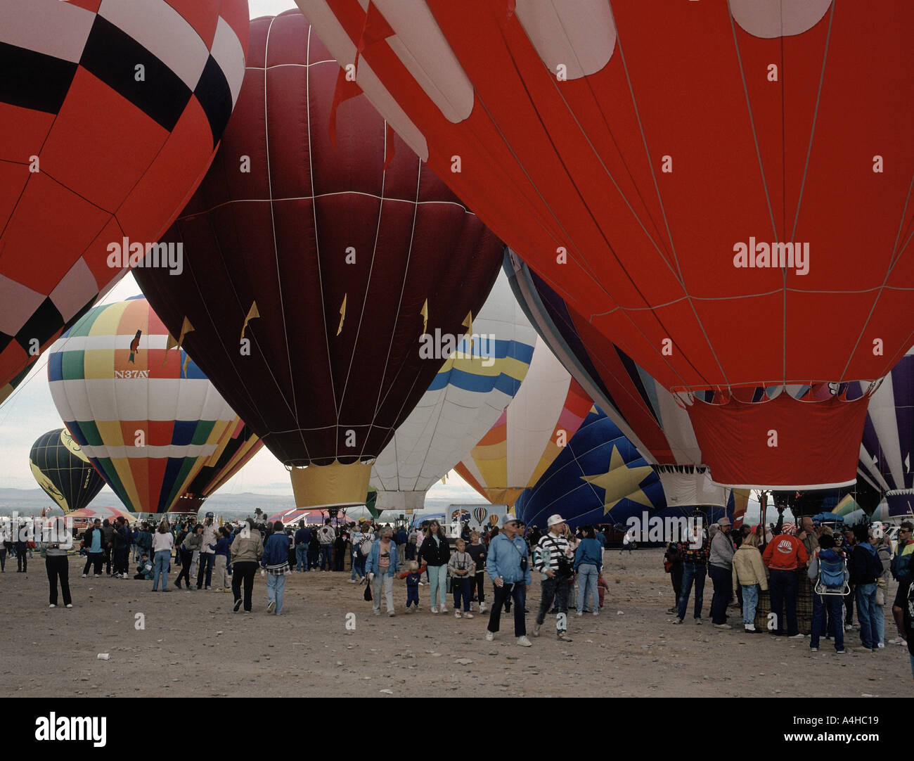 Humans on the ground dwarfed by the gigantic inflated hot air balloons ...