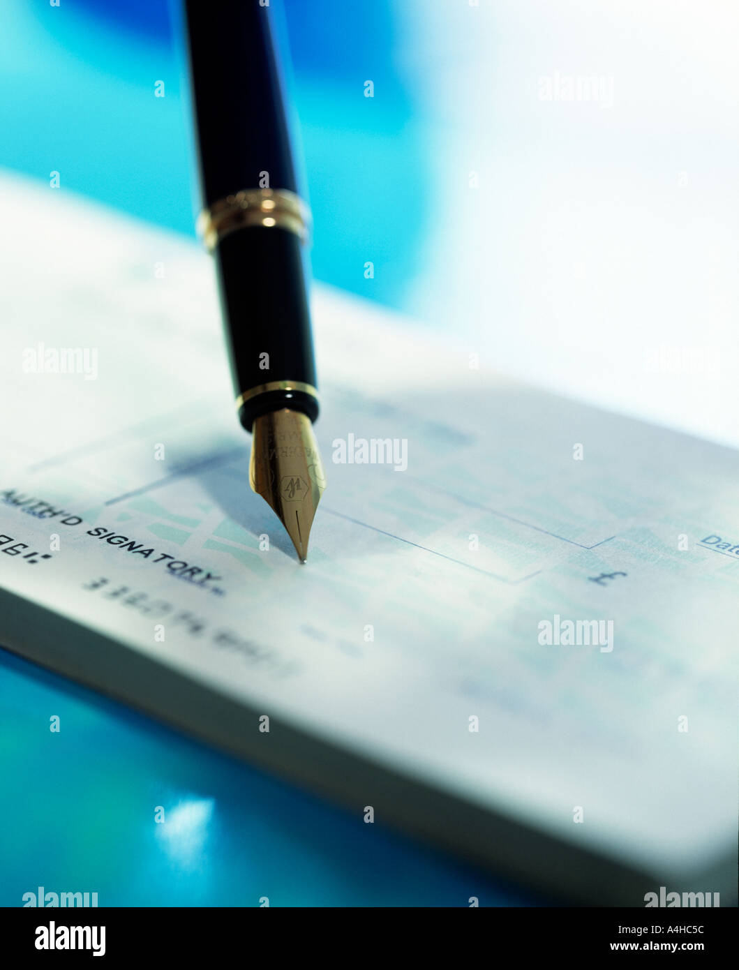 Cheque book and pen Stock Photo - Alamy