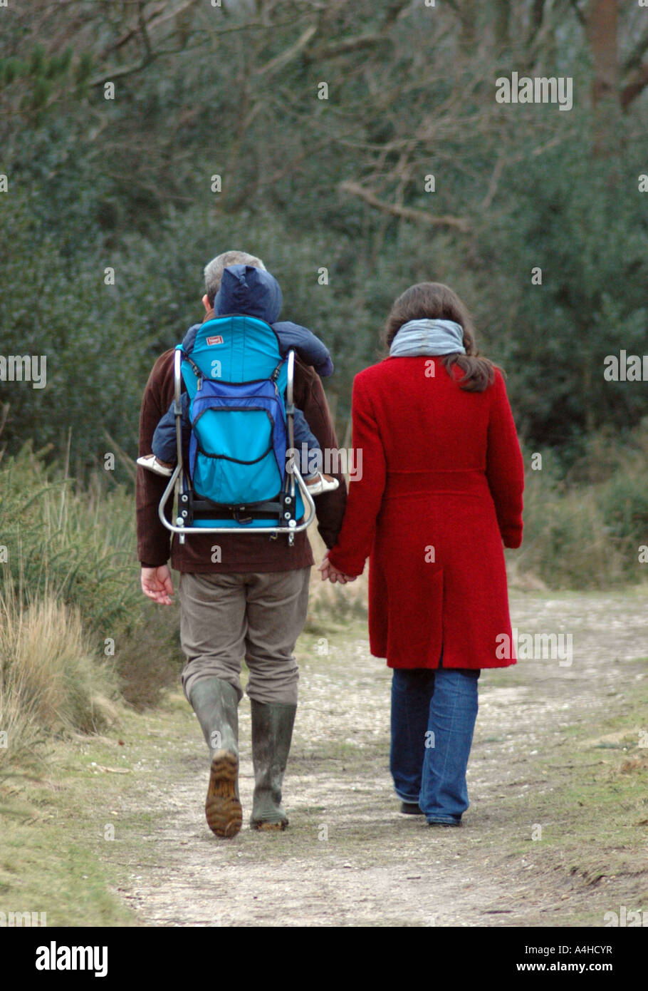Couple walking down a country track at Thorncombe Woods in England UK ...